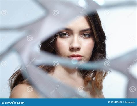 Young Woman Looks In A Broken Mirror Portrait Of Beautiful Female In
