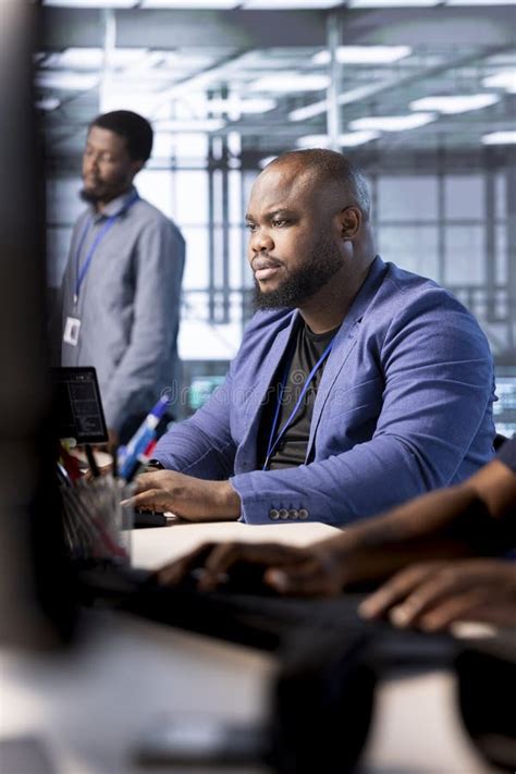 System Administrator In Data Center Protecting Company Critical Infrastructure Stock Image
