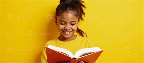 Cheerful Africanamerican Girl Reads On Vibrant Yellow Background