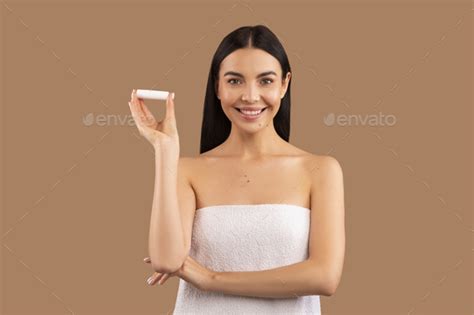 Beautiful Half Naked Woman Showing Her Balm For Lips Beige Background Stock Photo By Prostock