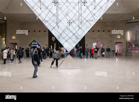 People In Paris France Gather Around The Captivating Inverted Pyramid