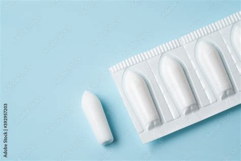 Suppository For Anal Or Vaginal Use On A Blue Background Candles For Treatment Of Hemorrhoids