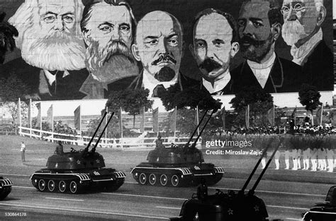 Tanks Pass By A Mural With Different Revolutionary Figures Marx