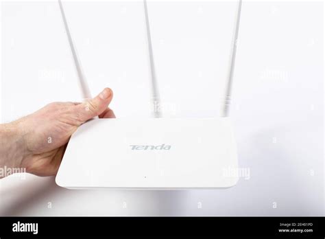 White Wifi Router Tenda With Three Antennas In Hand On White Background Stock Photo Alamy