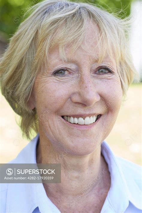 Outdoor Head And Shoulders Portrait Of Senior Woman Superstock