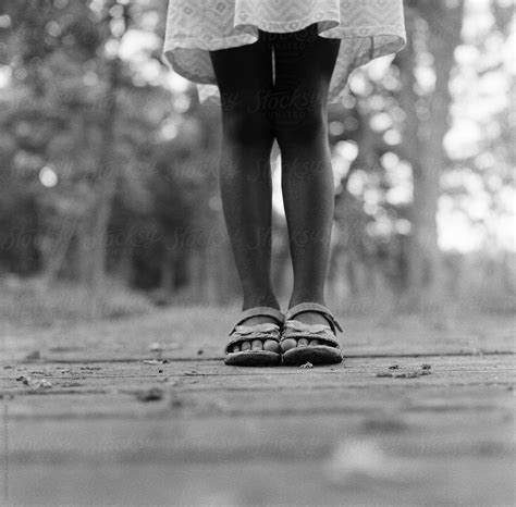 Black Girls Feet On A Wooden Boardwalk In A Forest By Stocksy