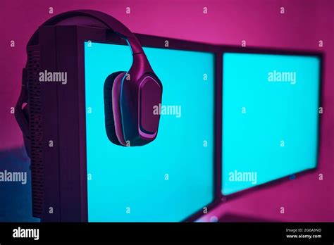 Wireless Headphones Hanging On Computer Display Blank Monitor To Insert Your Content
