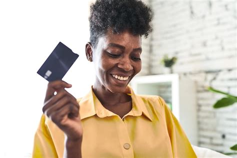 Premium Photo Cheerful African Woman In Her Living Room Proudly