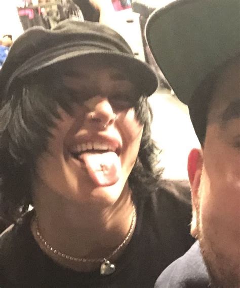 Two Men Wearing Hats And One Is Sticking His Tongue Out