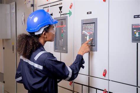 Electrical Young Asian Woman Engineer Examining Maintenance Cabinet System Electric And Using