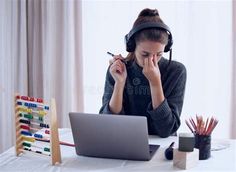 Stress Teacher And Woman With Headache In Home On Laptop For Online