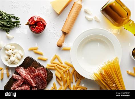 Top View Of Plate Bottle Of Olive Oil Meat Platter Rolling Pin