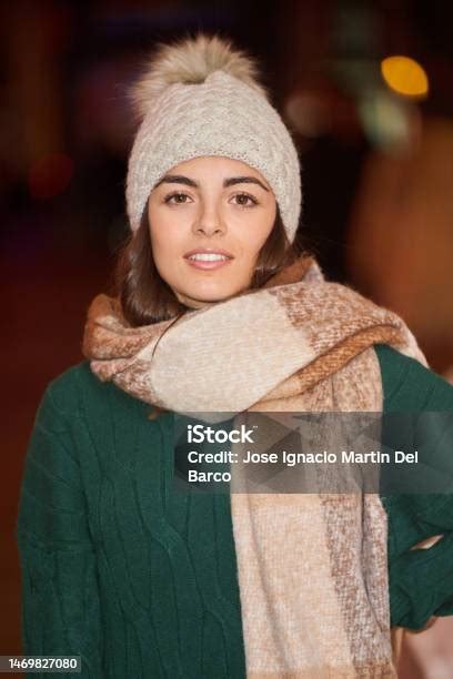 겨울 옷을 입고 모자를 쓴 여자가 야외에서 포즈를 취하면서 카메라를 보고 있다 스웨터에 대한 스톡 사진 및 기타 이미지 스웨터 보기 정적 활동 카메라 보기 Istock