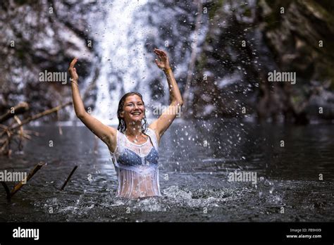 Young Beautiful Woman Bathing In A Forest Pond Near The Waterfall Stock