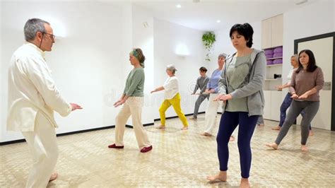 Concentrated Woman Exercising During Qi Gong Class Stock Video Video