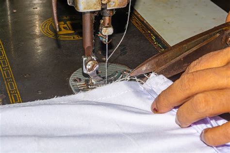 Indian Woman Hands Stitching White Cloth With The Help Of A Sewing
