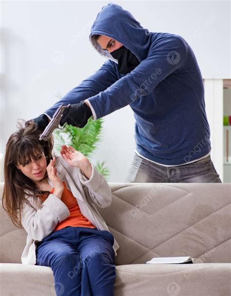 The Armed Man Assaulting Young Woman At Home Armed Man Assaulting Young