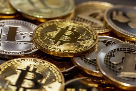 An Arrangement Of Bitcoin Coins Piled On A Table Showcasing Digital
