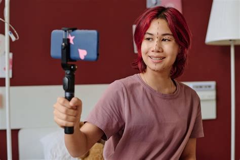 Premium Photo Cute Smiling Teenager With Smartphone On Stick Standing