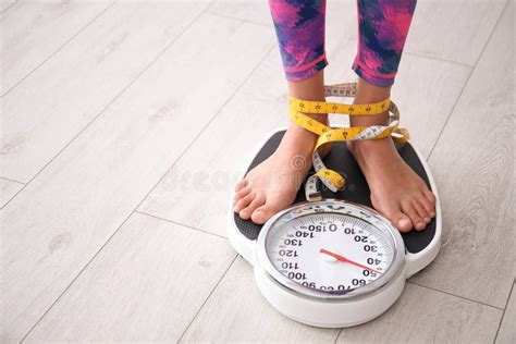 Woman Tied With Tape Measuring Her Weight Using Scales Stock Photo Image Of Nutrition