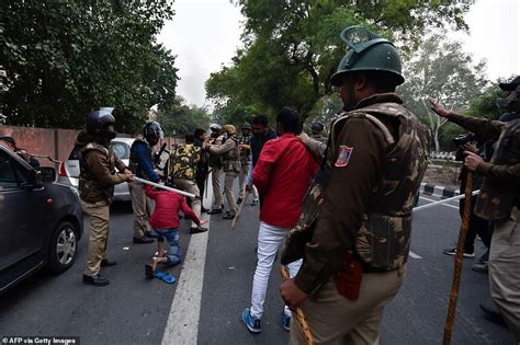 Bus Is Set On Fire And Police Fire Tear Gas At Protesters In New Delhi