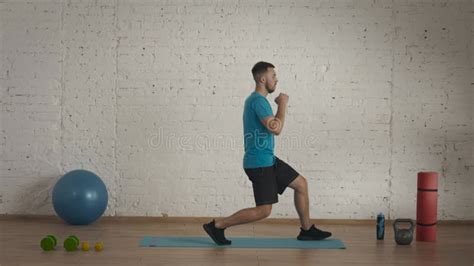 Man Fitness Instructor In Sportswear Doing Lunges Exercise For Online