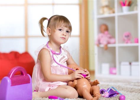 Small Beautiful Girl Listens By Means Of Stock Image Image Of Home