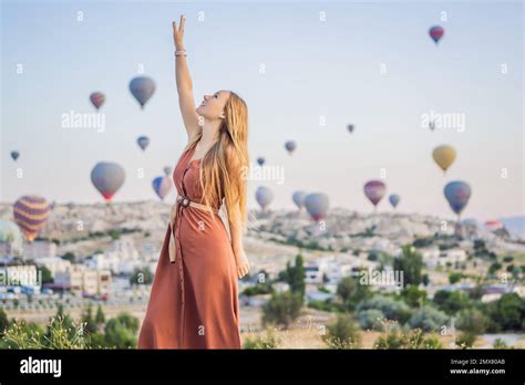 Tourist Woman Looking At Hot Air Balloons In Cappadocia Turkey Happy