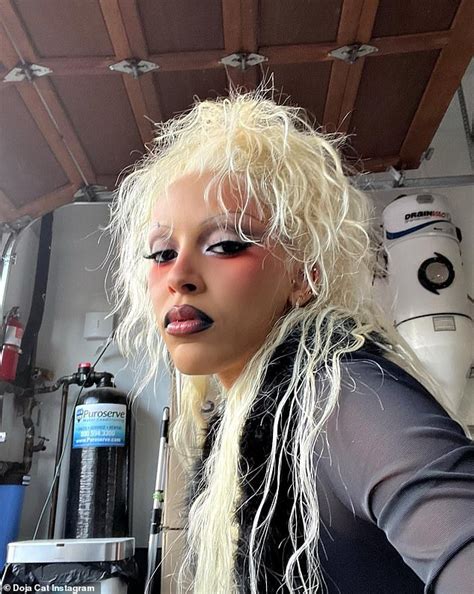 Doja Cat Puts On A Very Busty Display Donning A Black Cutout Bodysuit And Platinum Blonde Wig