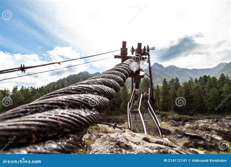 Close Up On A Metal Binding Cable Going In Perspective To The Bridge