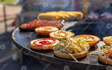 Close Up View Of A Flat Top Grill Showcasing The Final Stages Of Assembling Burgers Toasted