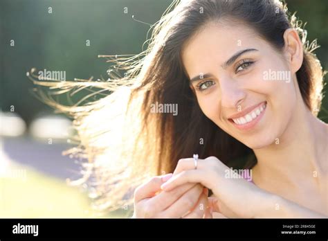 Happy Fiancee Showing Engagement Ring Looking At Camera In A Park Stock