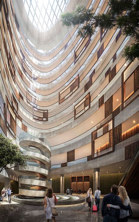 People Are Walking Around In The Middle Of A Building With Many Windows