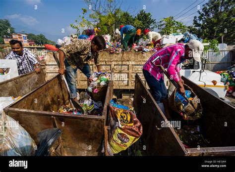 People Are Collecting Garbage In The City Loading It On Trucks And