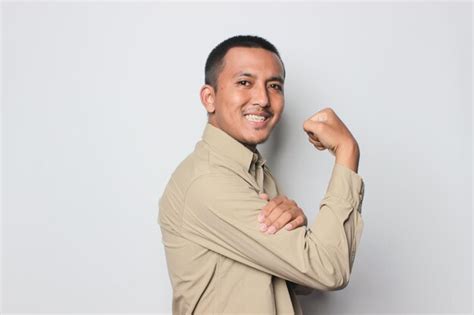 Premium Photo A Man Flexes His Muscles With His Arms