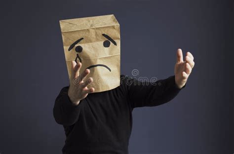 Sad Man With A Bag On His Head With A Drawn Crying Emoticon Stock