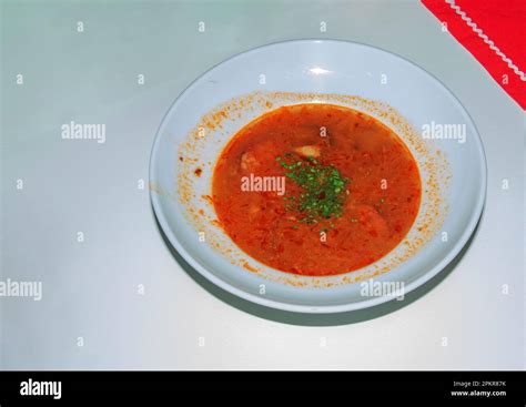 Bowl Of Hot Chicken Broth With Noodles On A White Background A Glass