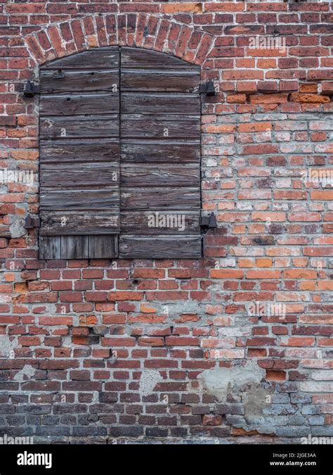Red Brick Wall With Wooden Doors Of Old Abandoned Port Warehouse