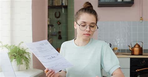 Yong Woman Budgeting Managing Utilities Expences Writing Financial