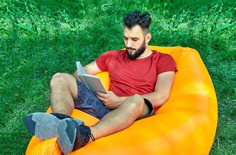 Premium Photo Young Man Sitting On Grass