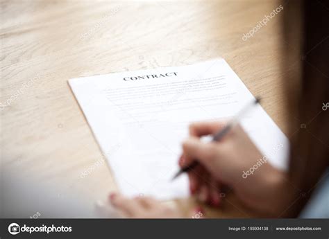 Female Hand Putting Signature On Business Contract Focus On Doc Stock Photo Fizkes 193934138