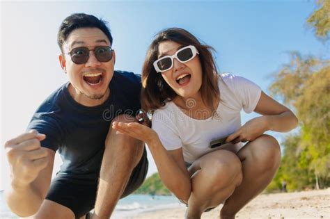 Playful Couple Lovers Taking Photo Together At The Beach Low Angle