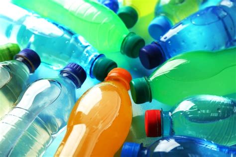 Premium Photo Bottled Water On The Blue Background Close Up