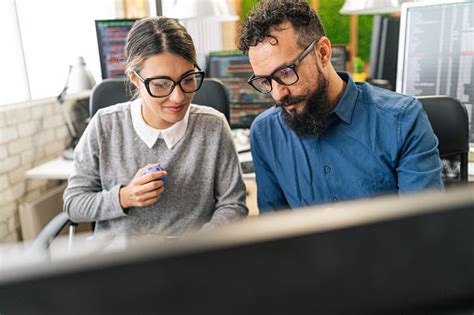 Software Programmers Analyzing Html Code And Database Brainstorming Script Ideas To Develop New