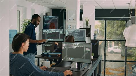 premium photo diverse team of database developers analyzing code on