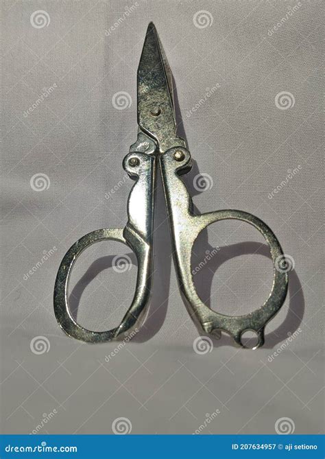 A Pair Of Scissors In Front Of The Cloth Under The Lightï¿¼ Stock Image