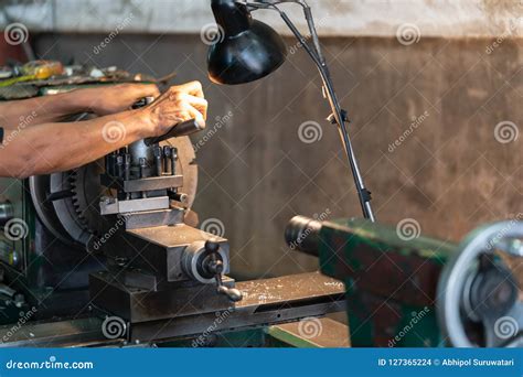 Professional Machinist Man Operating Lathe Grinding Machine