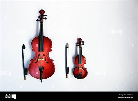 Classic Stringed Instruments Cello And Violin Isolated On White