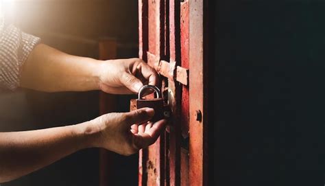 Premium AI Image A Man Opening A Padlock And Removing The Security To Enter Or Leave The Premises