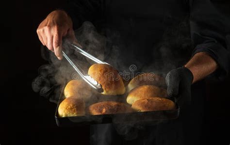 The Baker Bakes Pies Or Buns On A Hot Baking Sheet Taken Out Of The